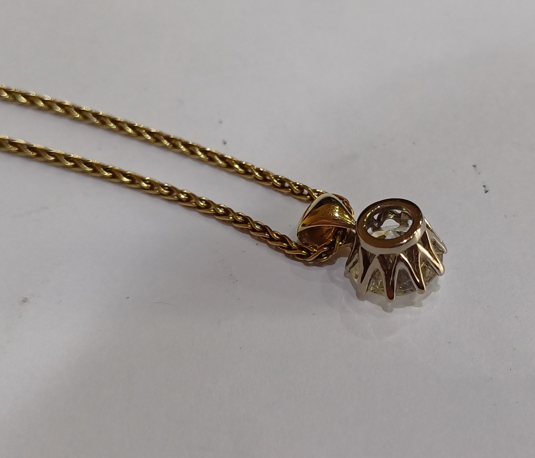 A Diamond Solitaire Pendant on Chain the round